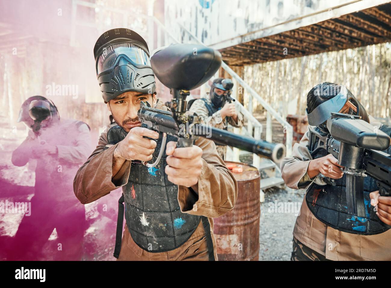 Teamwork, shooting and paintball with man in game for playground, war ...