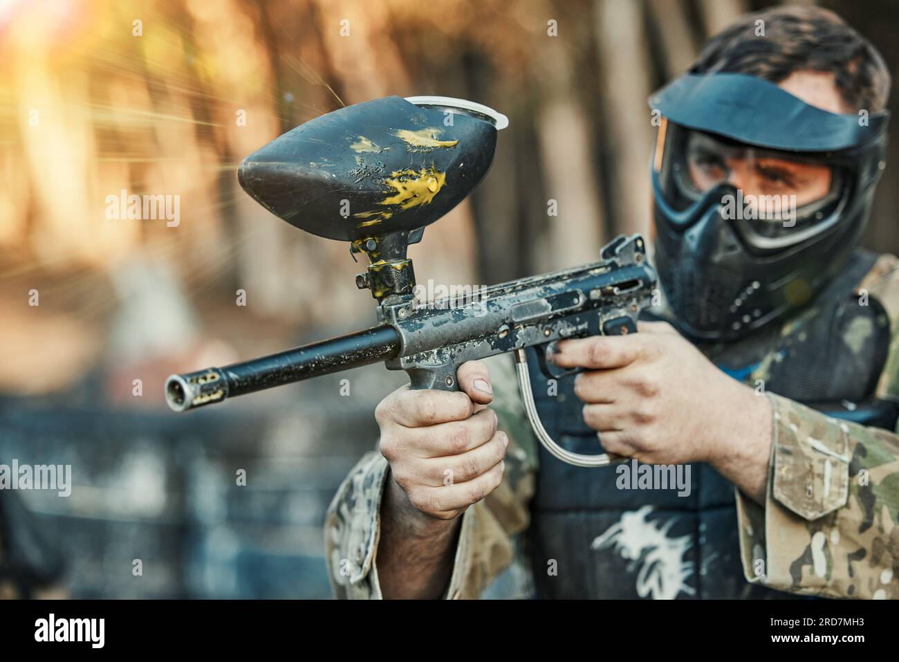 Paintball, sports and man shooting with gun for tournament, competition ...