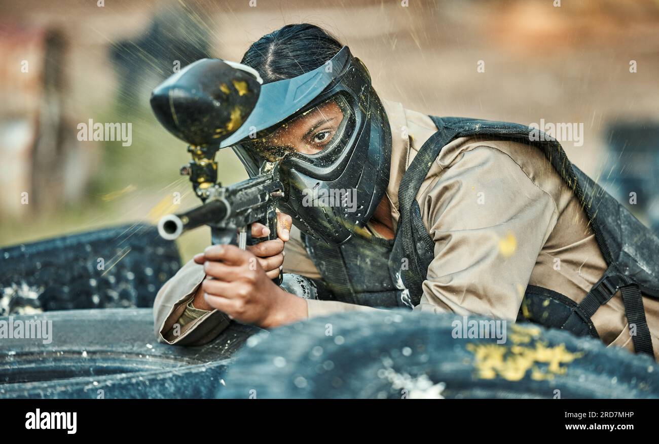 Paintball, sports and woman in action with gun for tournament ...