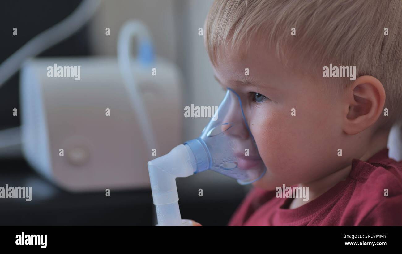 Funny boy breathing through an inhaler mask Stock Photo - Alamy