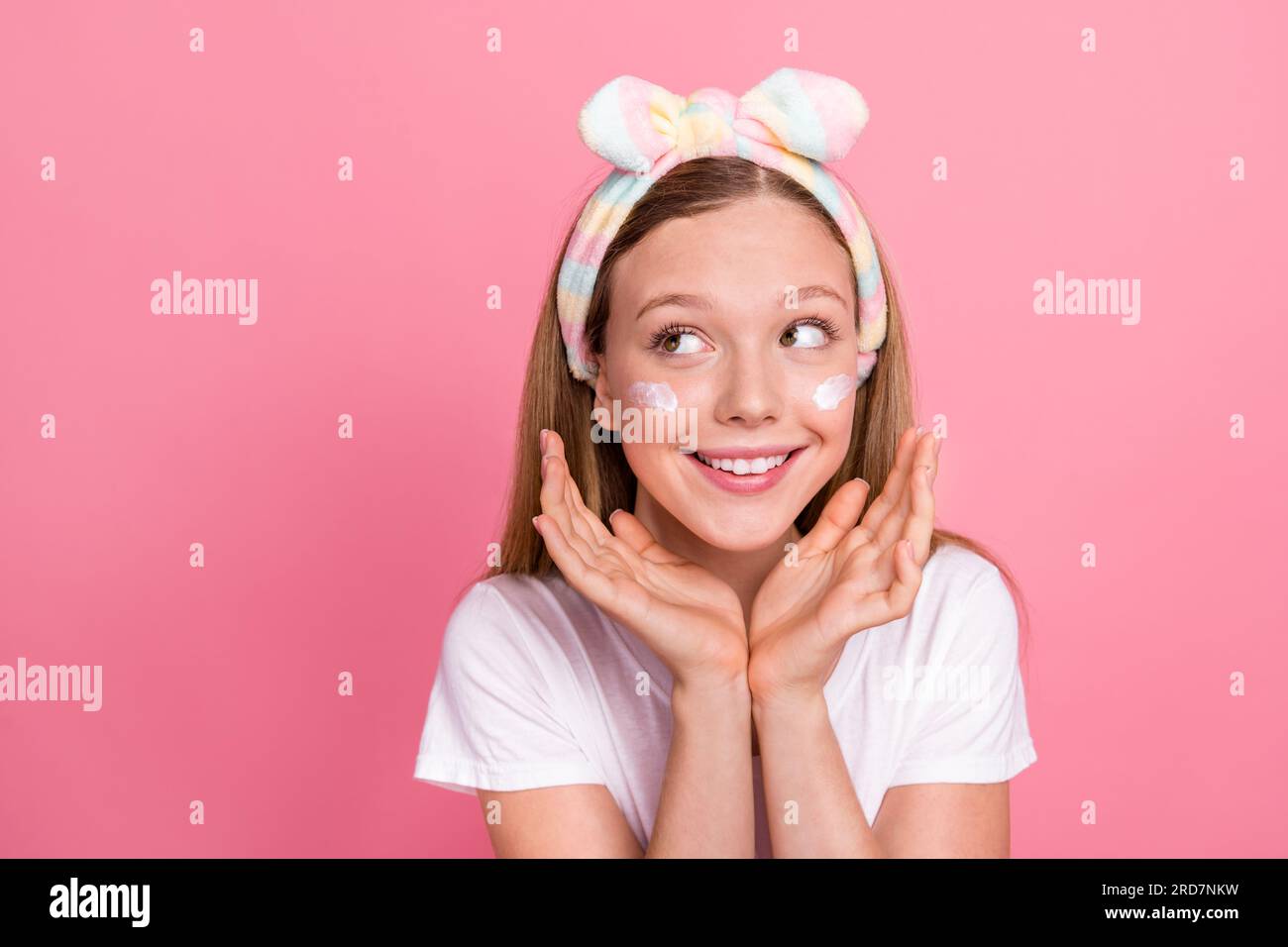 Portrait of adorable sweet girl hands under face apply hydration balm ...