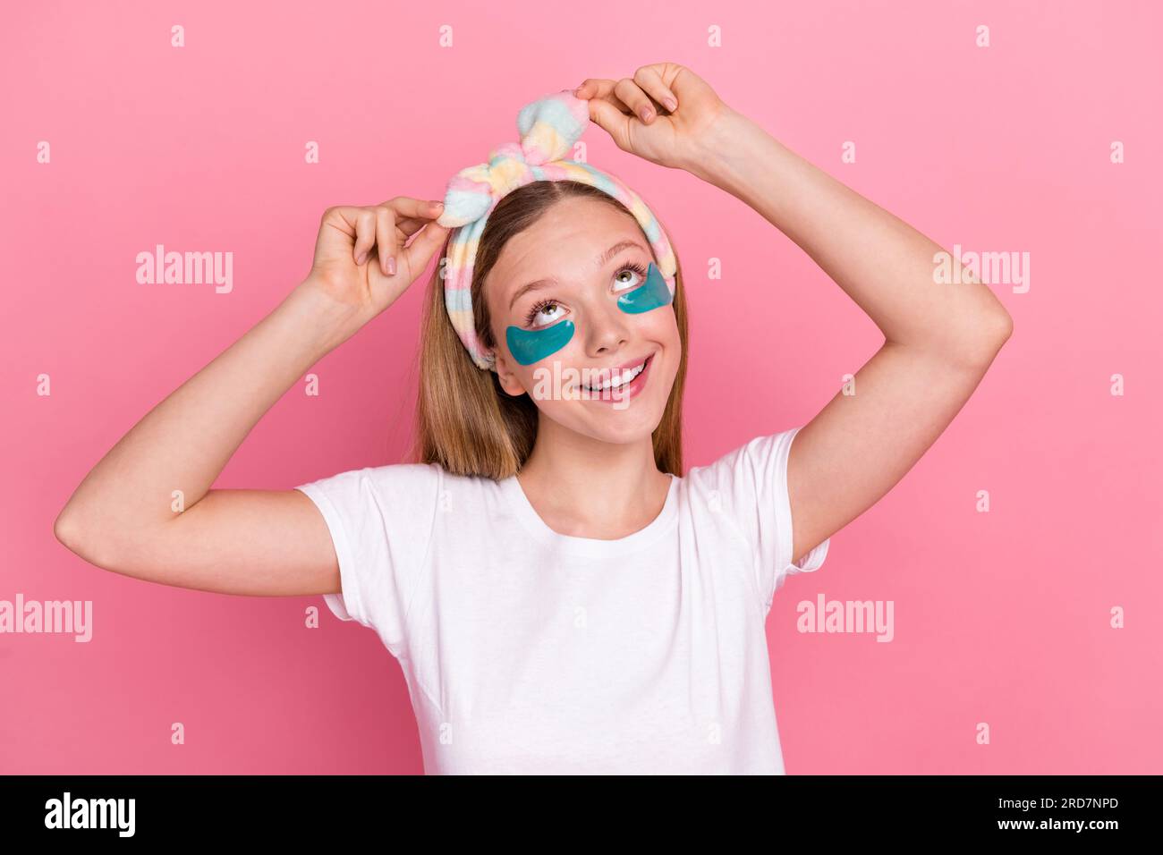 Photo of cheerful cute girl hands tying headband accessory apply under ...
