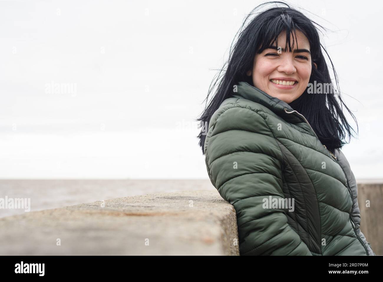 portrait of young latin woman of venezuelan ethnicity, standing leaning ...