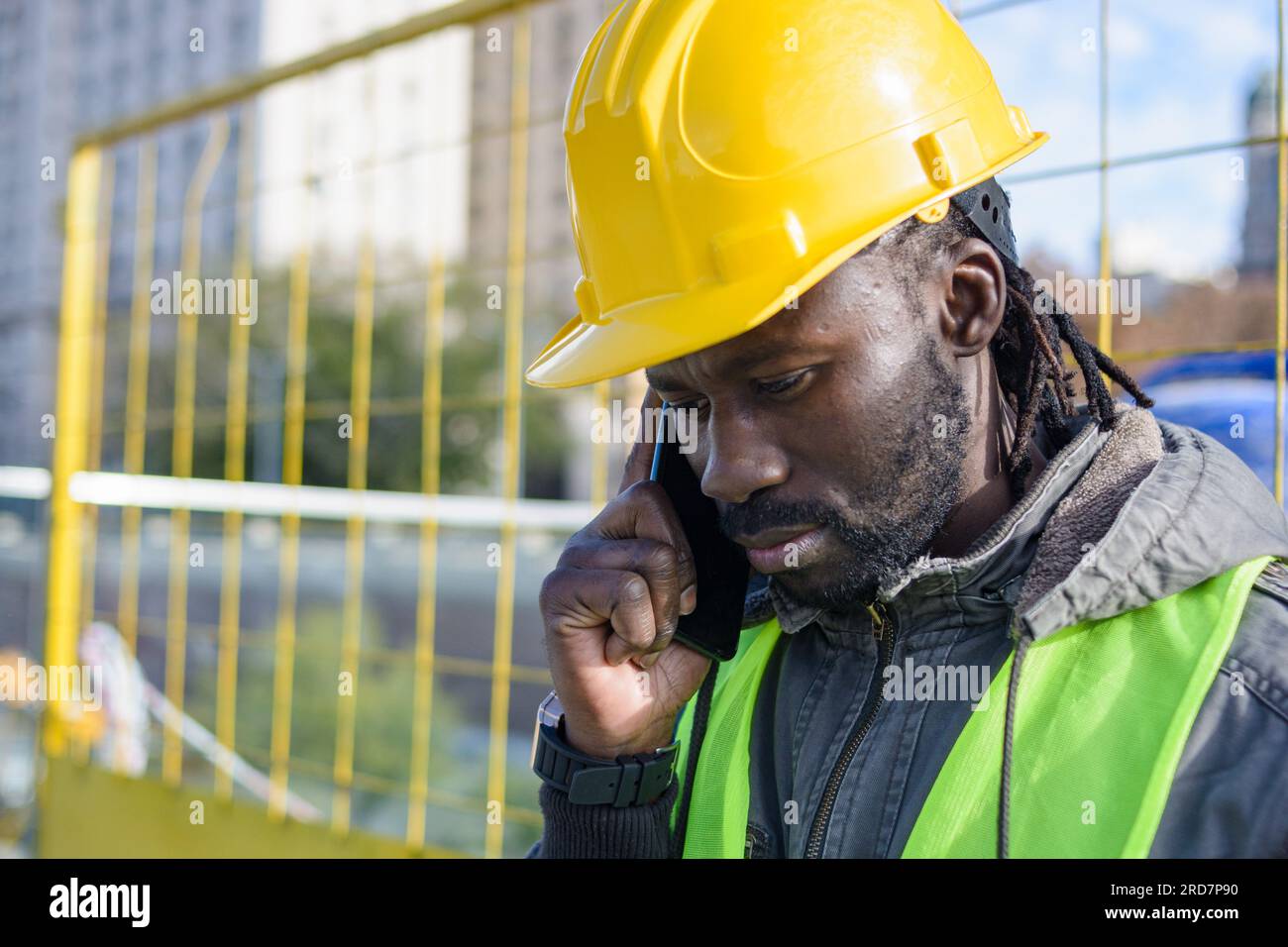 young black male builder employee wearing yellow safety helmet ...