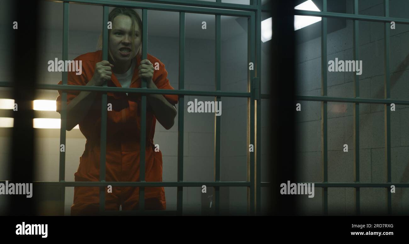 Insane Female Prisoner In Orange Uniform Yells At Neighbor Inmate Jumps On Bars In Prison Cell 1868