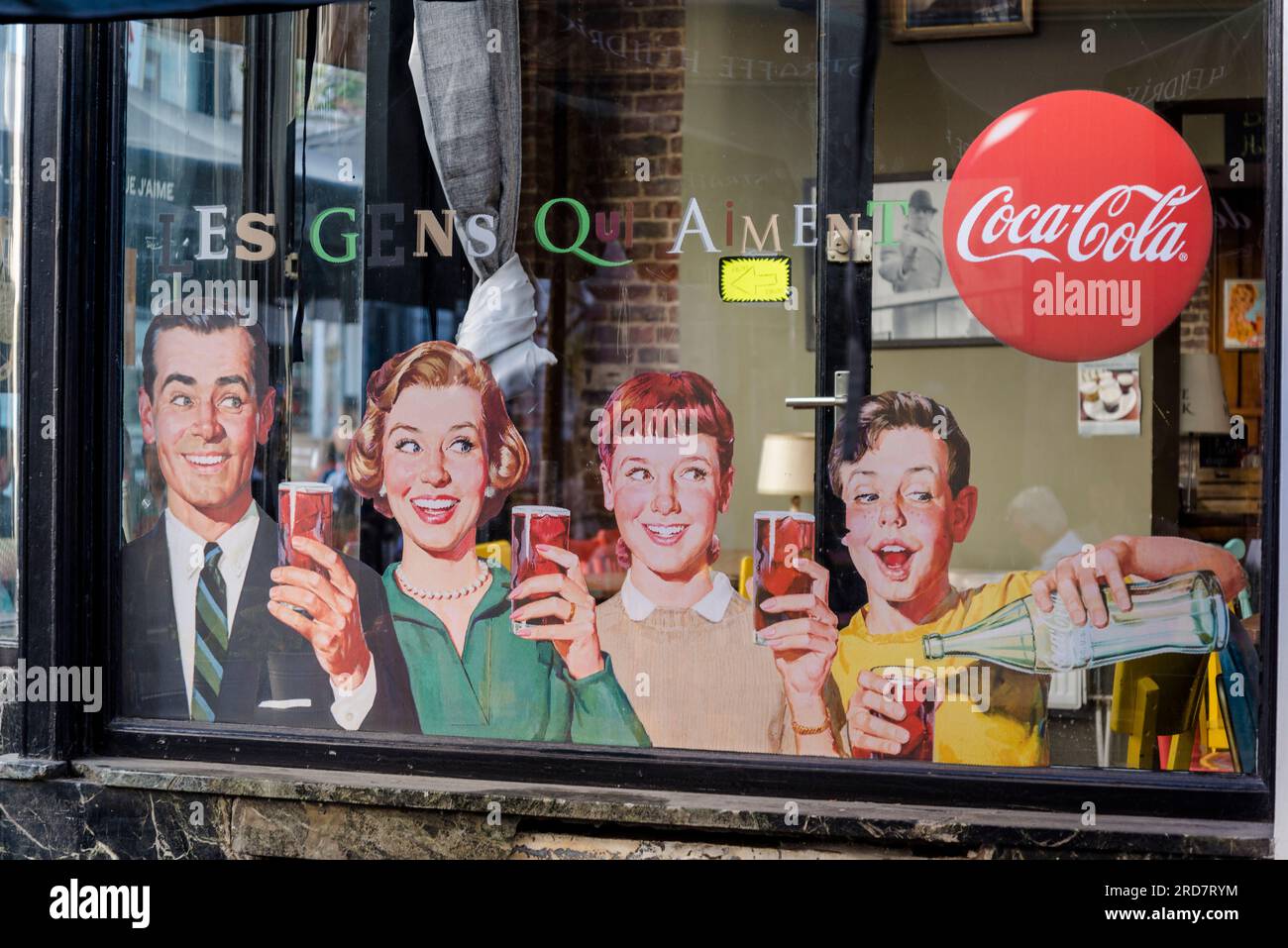 1950 ideal family advertisement for Coca-Cola in a cafe window ...