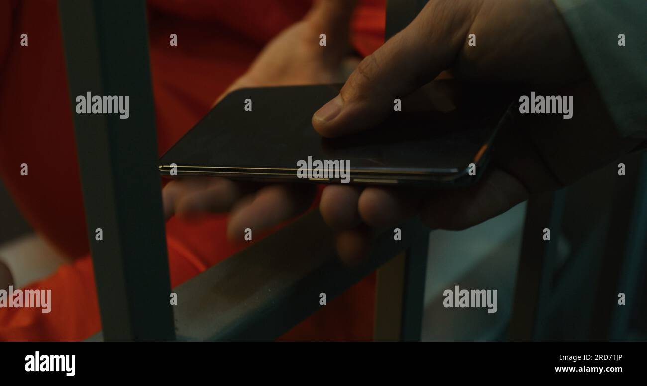 Prison employee gives phone to female prisoner. Woman criminal in ...