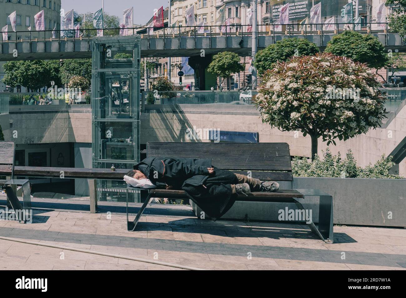 May 7, 2023, Budapest, Hungary: A homeless man seen sleeping on a bench ...