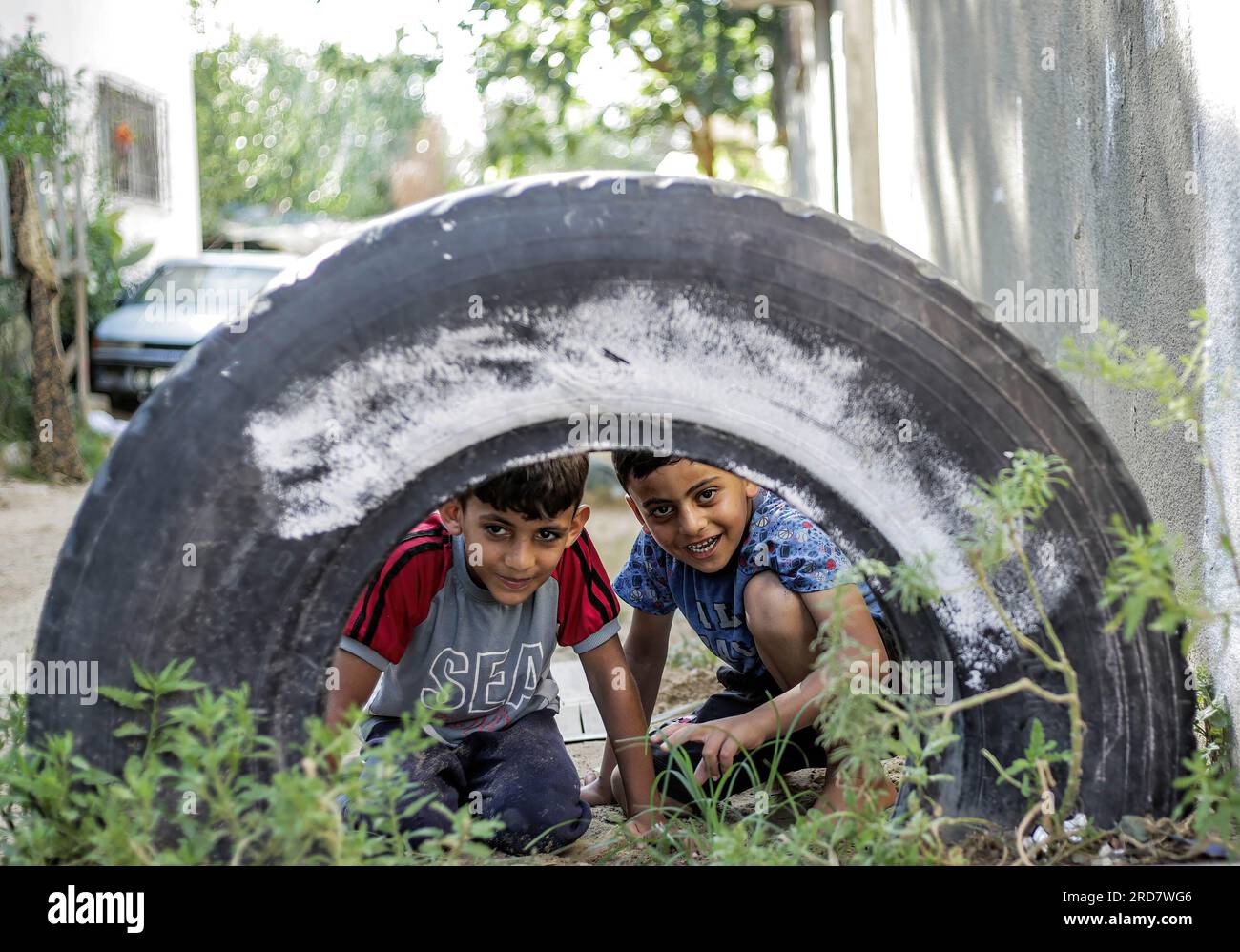 Palestinian children play in front of the family home in the town of ...