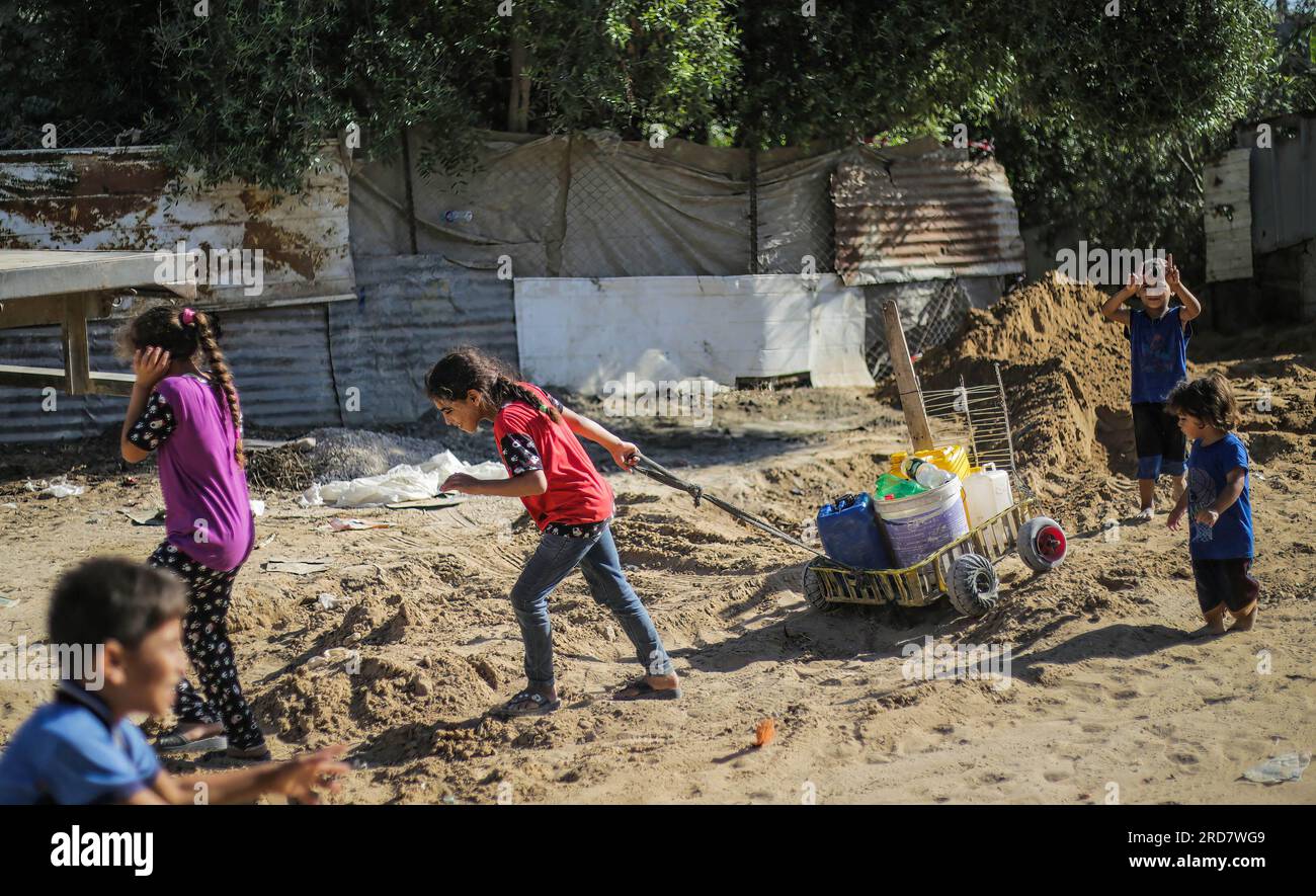 Palestinian children fetch water near their family home in the town of ...