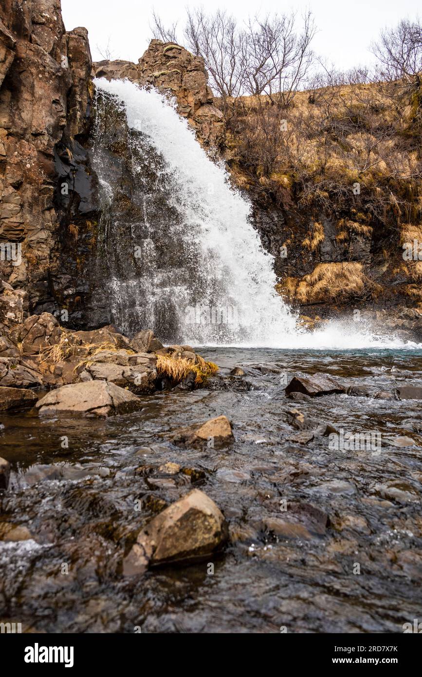 The small Magnúsarfoss waterfall, fed from Stórilækur river, hidden in ...