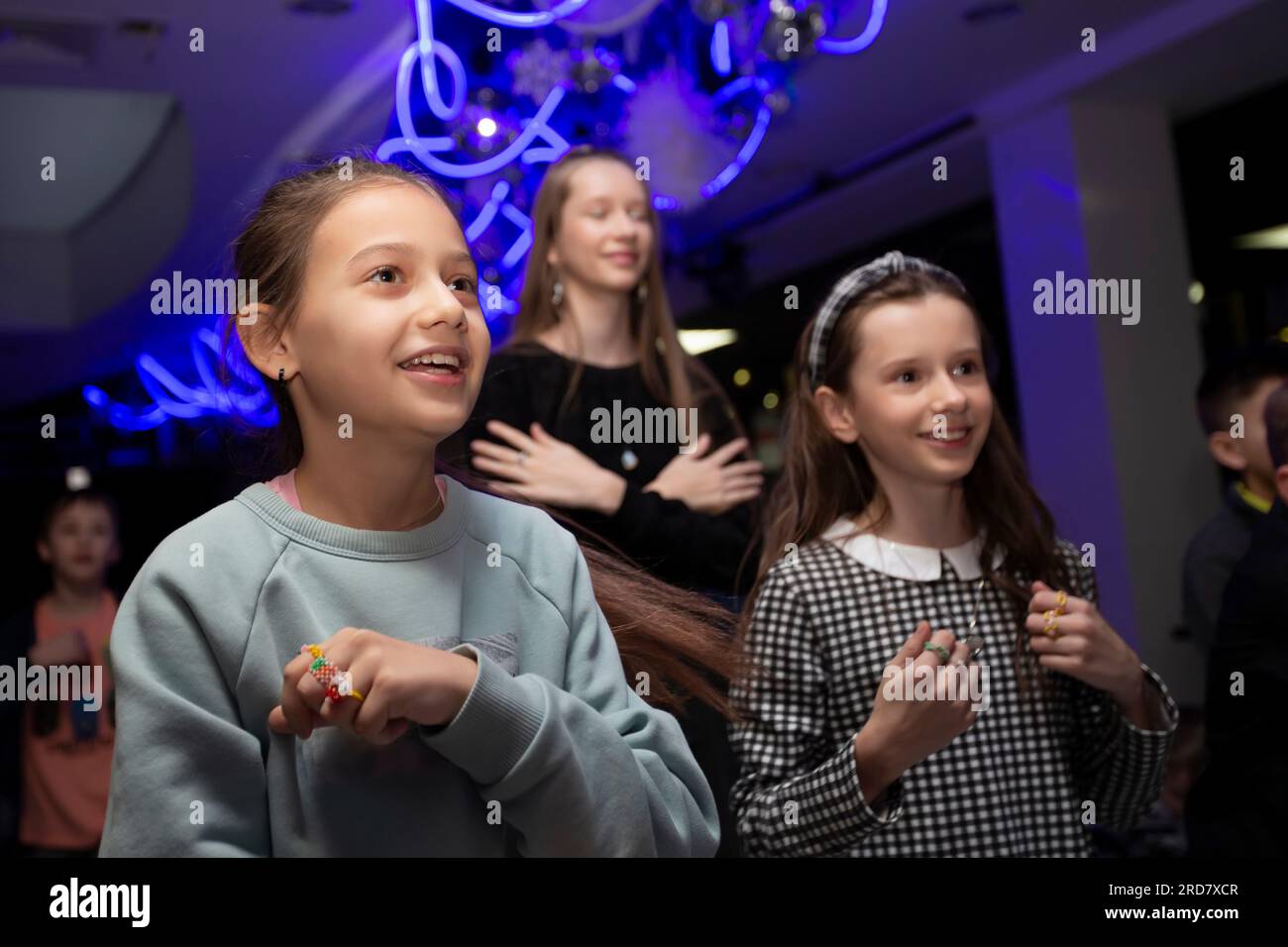 Happy kids dancing at a holiday party in the club, celebrating a ...