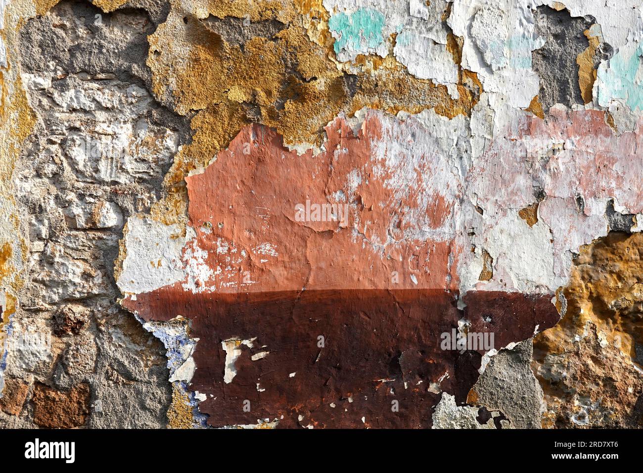Old colorful scabrous uneven damaged repairing wall painted surface as ...