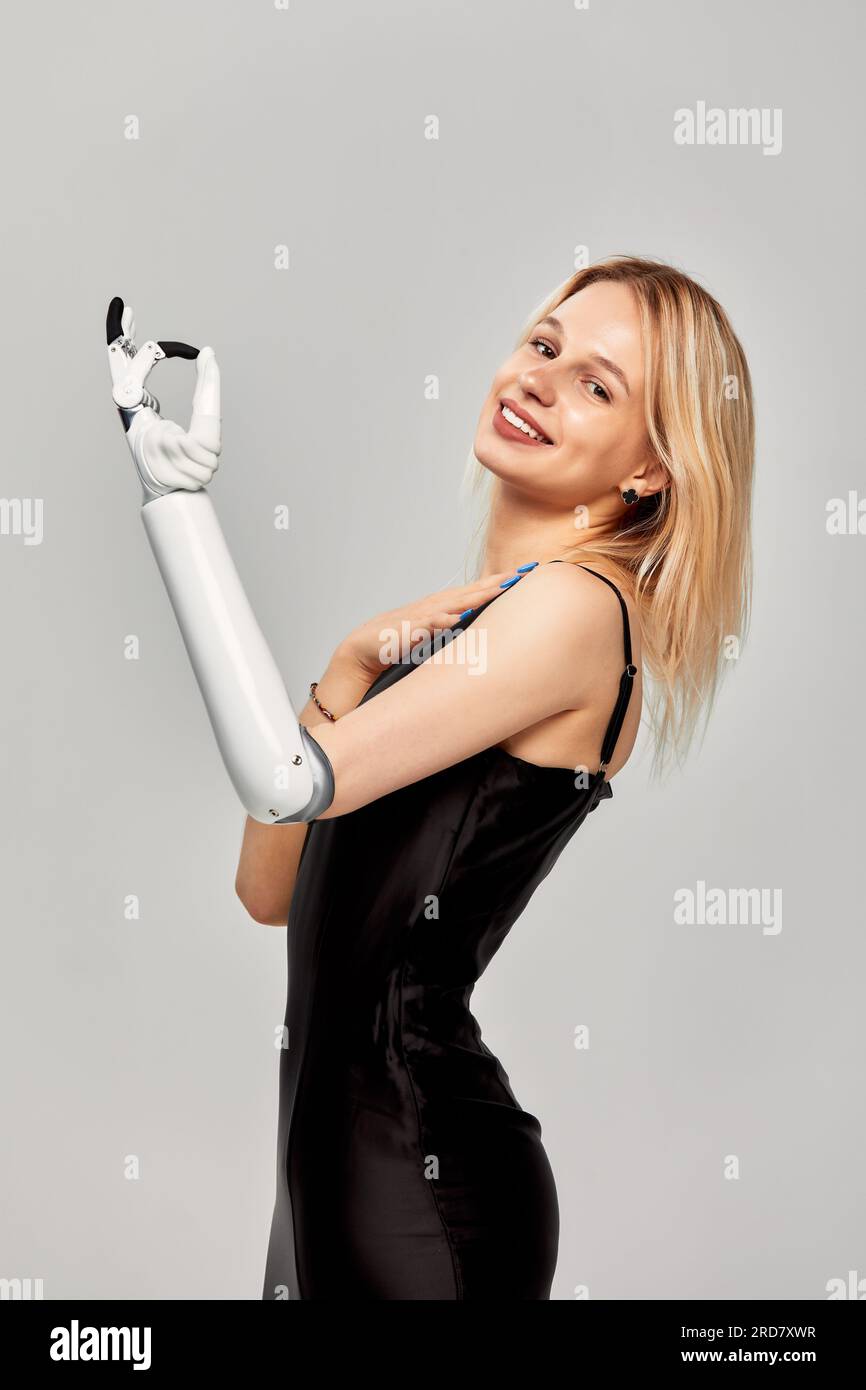 Studio portrait of beautiful young blonde girl with disability wearing ...