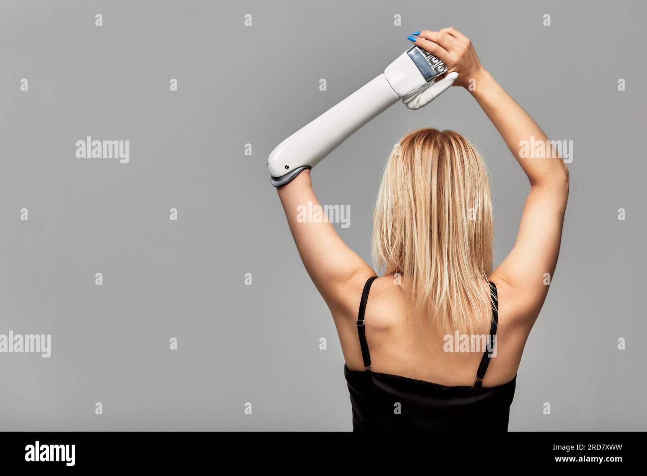 Studio portrait of beautiful young blonde girl with disability wearing ...