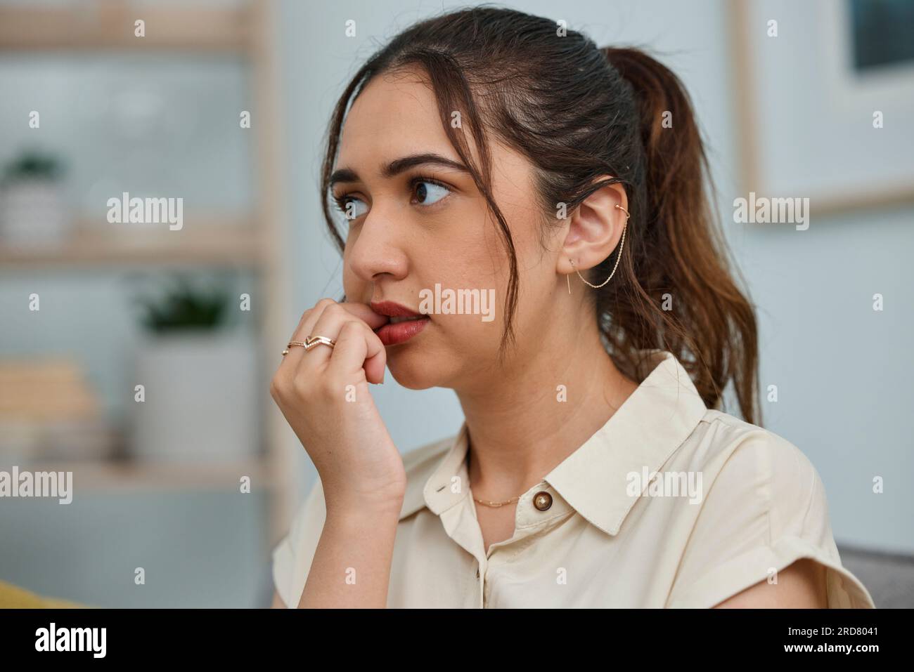 Biting, nails and woman with anxiety, stress and mental health risk at home. Scared, fear and ...