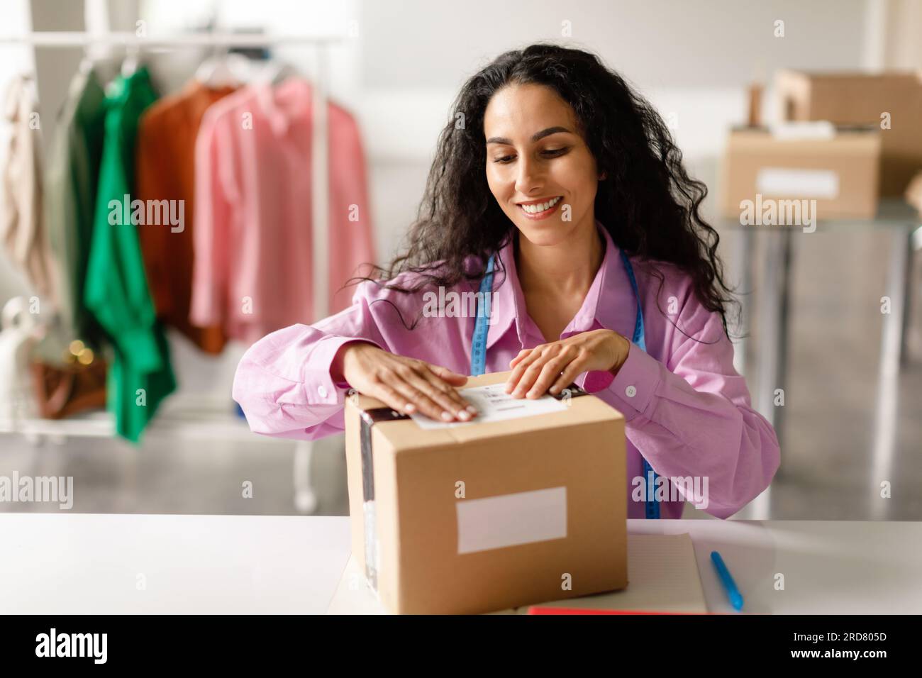 Fashion Designer Packaging Garments Preparing For Delivery In Clothing ...