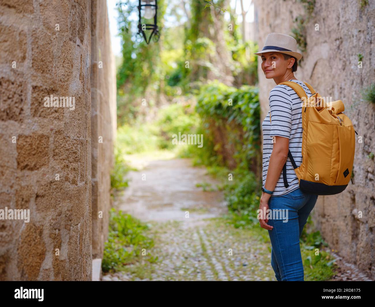 summer trip to Rhodes island Greece. Young Asian woman in striped ...