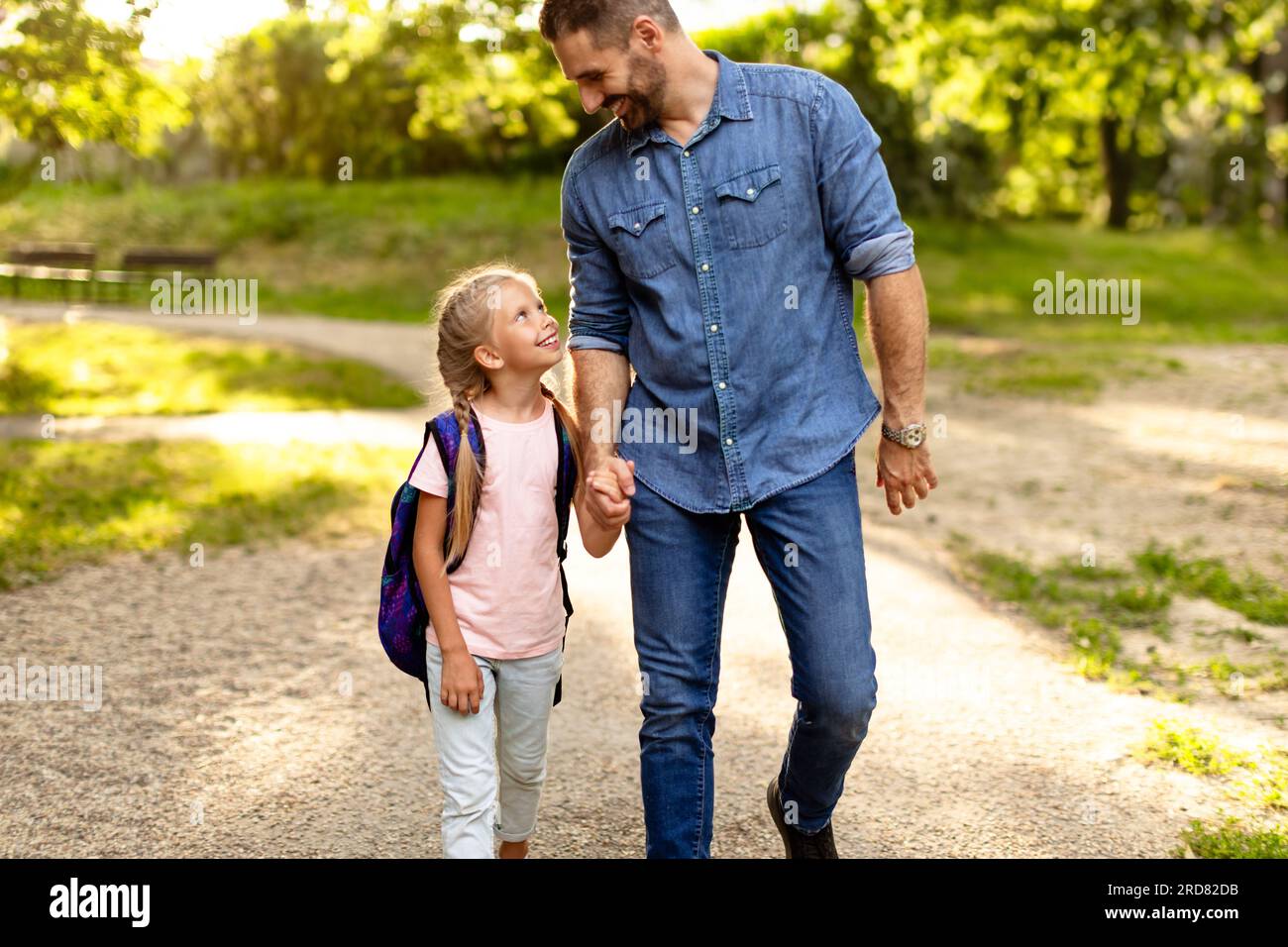 First day at school. Happy father leading his little child school girl ...