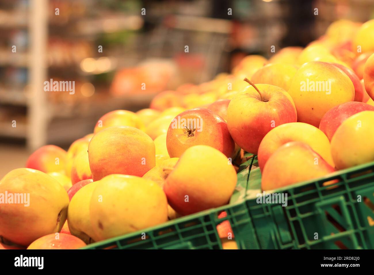 Apples in plastic boxes in a store, close-up. Ripe apples on sale, side ...