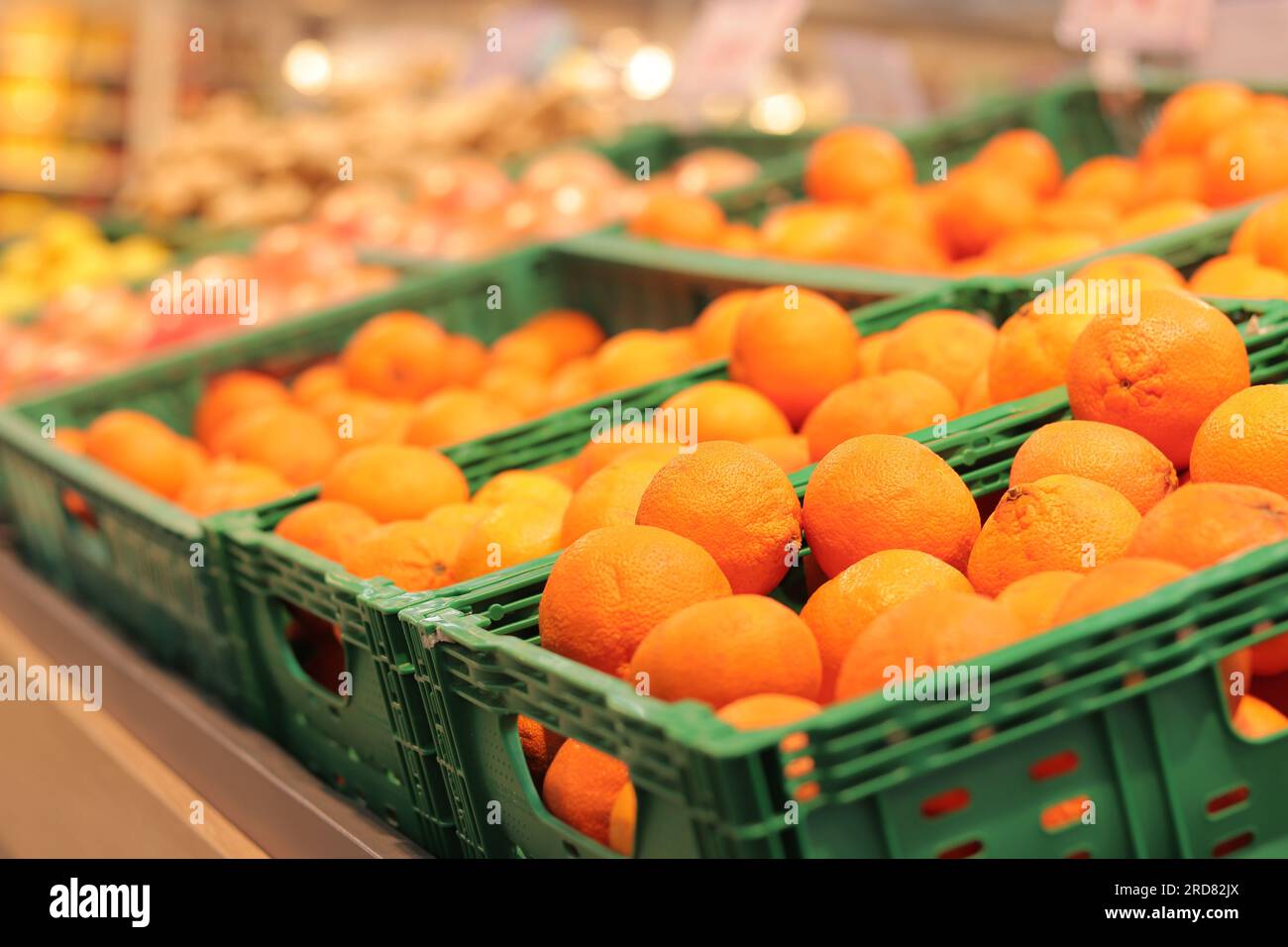 Sale of oranges in the supermarket. Citrus fruits in plastic boxes ...