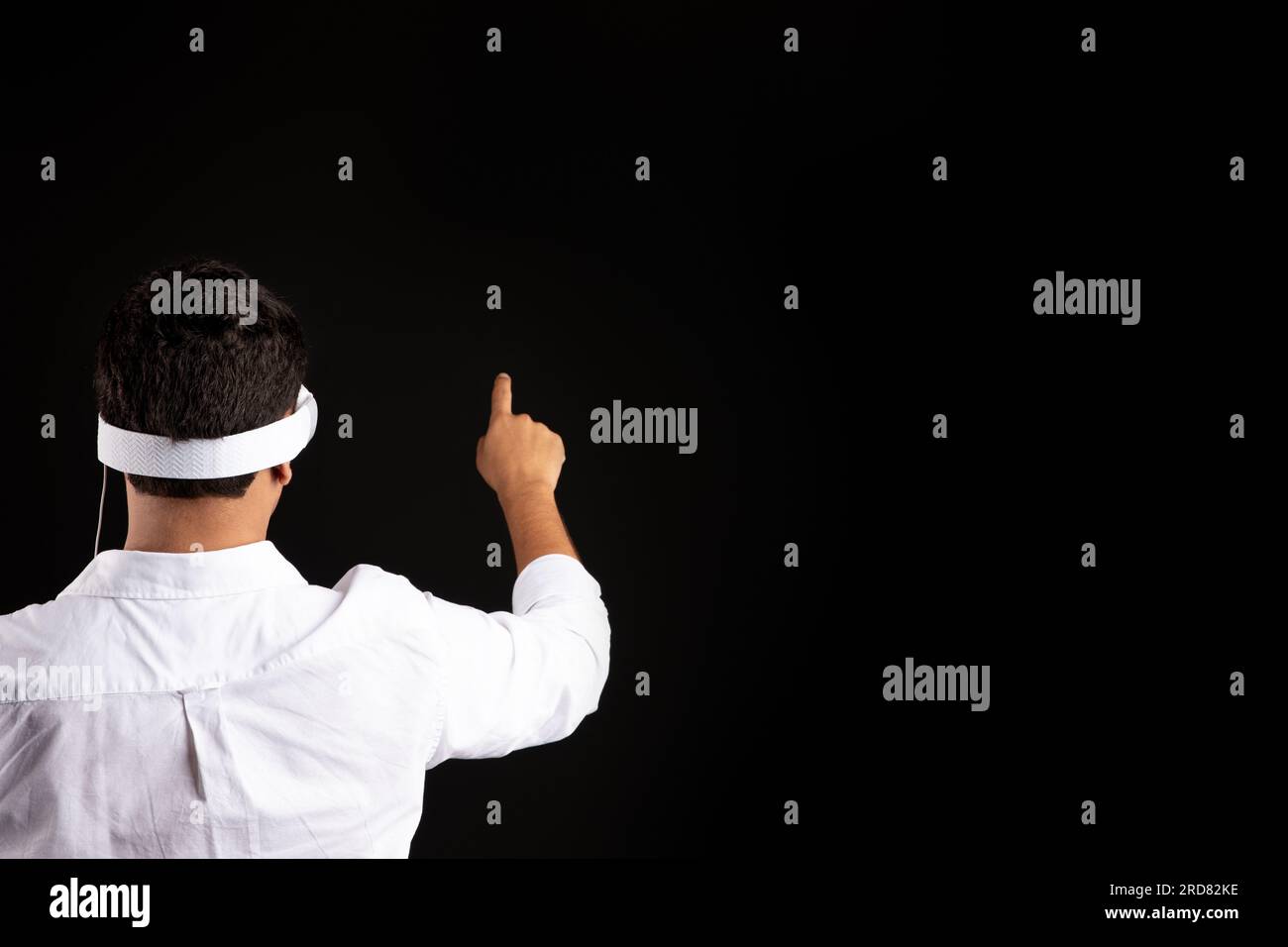 Back view of businessman wearing virtual reality googles pointing ...