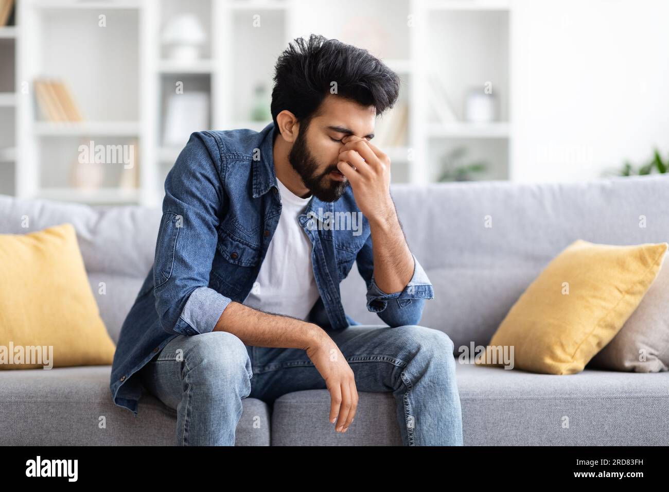 Seasonal Depression. Portrait Of Sad Indian Man Sitting On Couch At ...