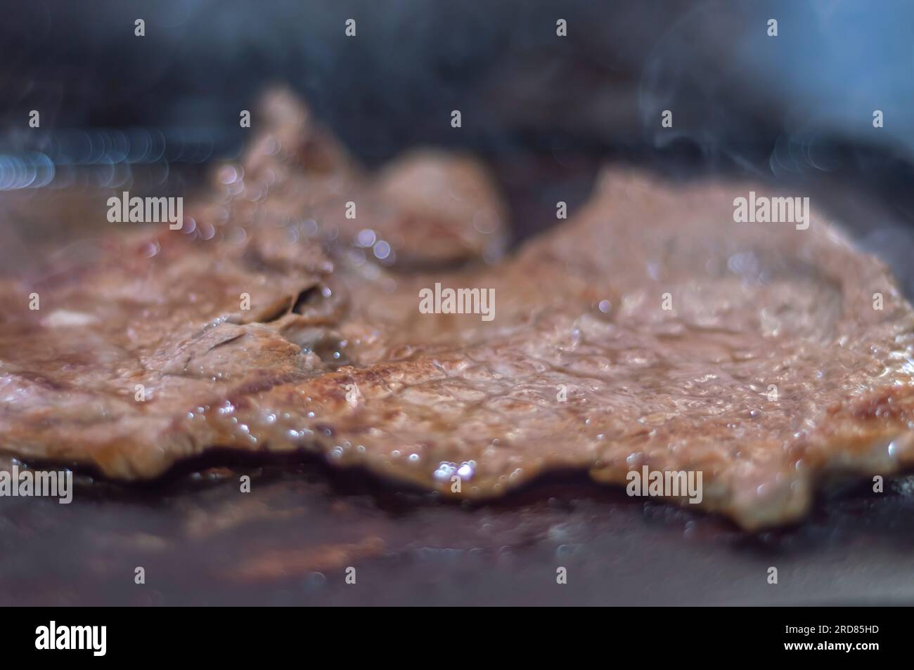 Concept of barbecue at home,Beef being prepared on a homemade stove ...