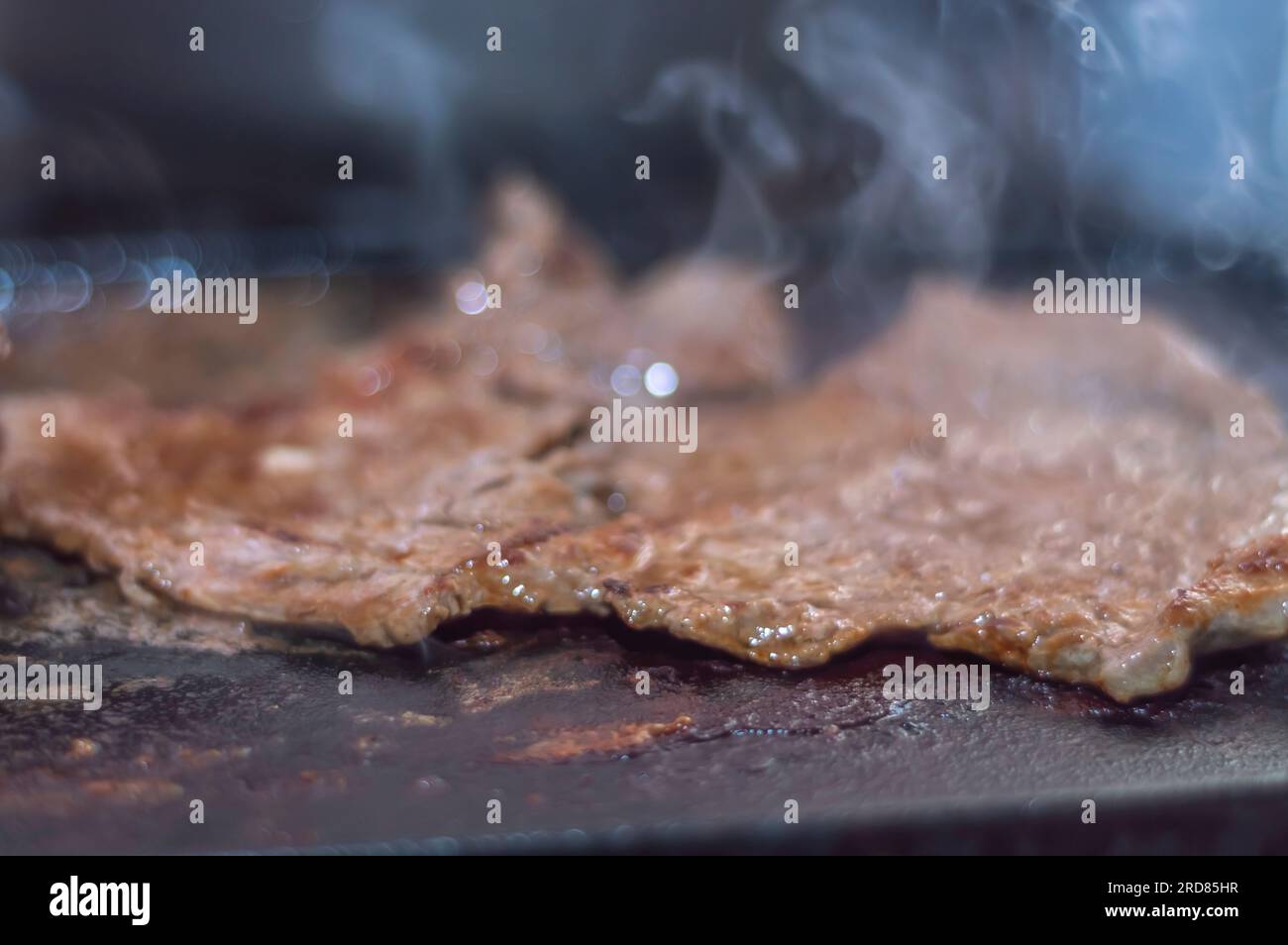Concept of barbecue at home,Beef being prepared on a homemade stove ...