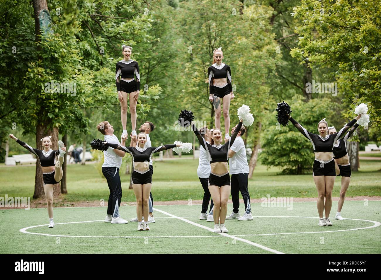 Cheerleading team dancing together at sport competition outdoors Stock ...
