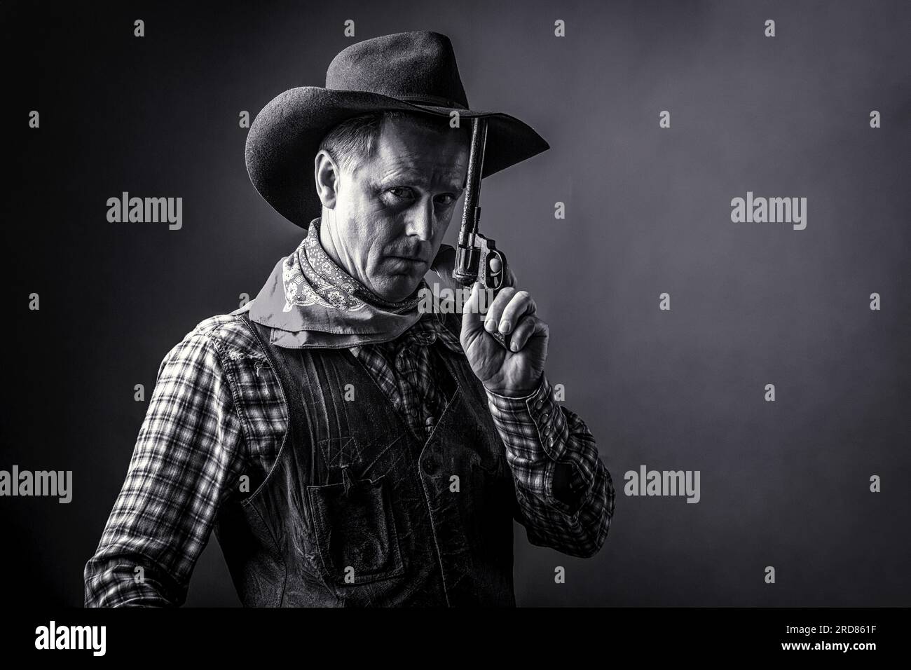 West, guns. Portrait of man wearing cowboy hat, gun. Portrait of a ...