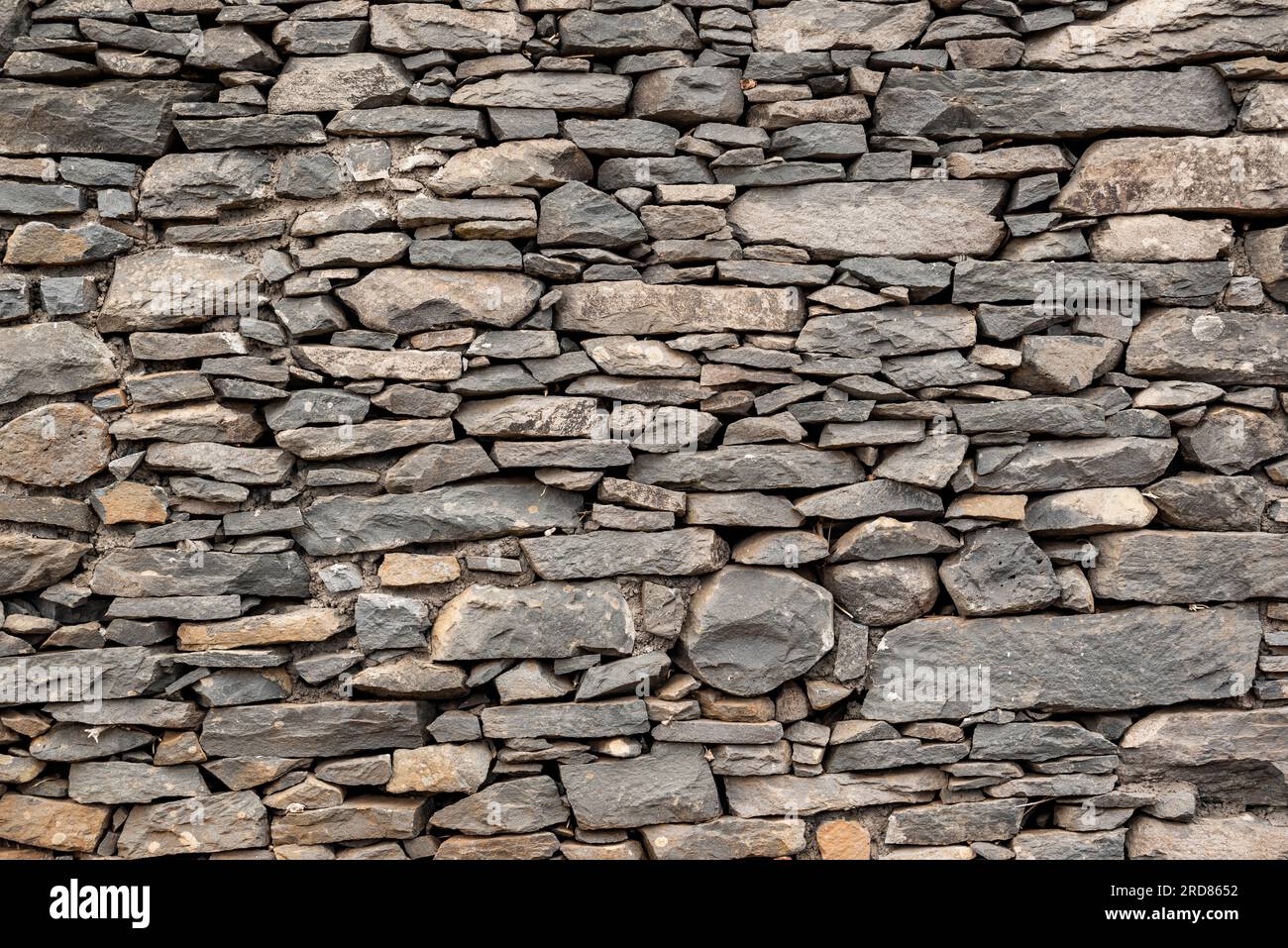 Rough natural stone wall background Stock Photo - Alamy