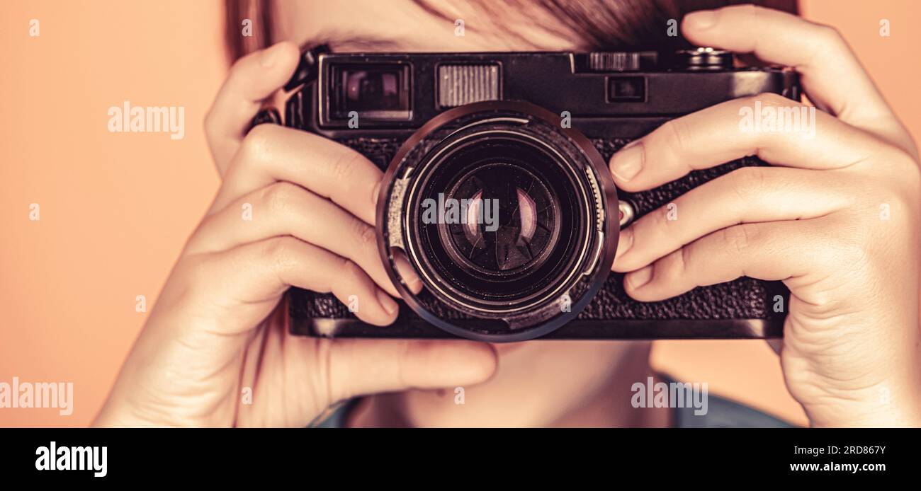 Cheerful smiling child holding a cameras. Little boy on a taking a ...