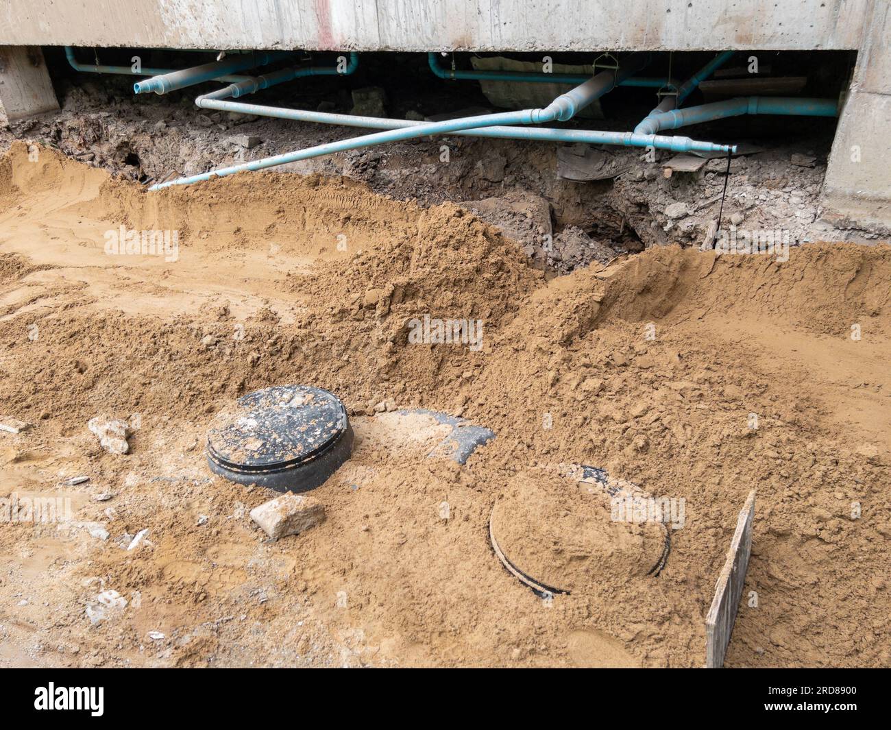 The installation of a septic tank near a building under construction of ...
