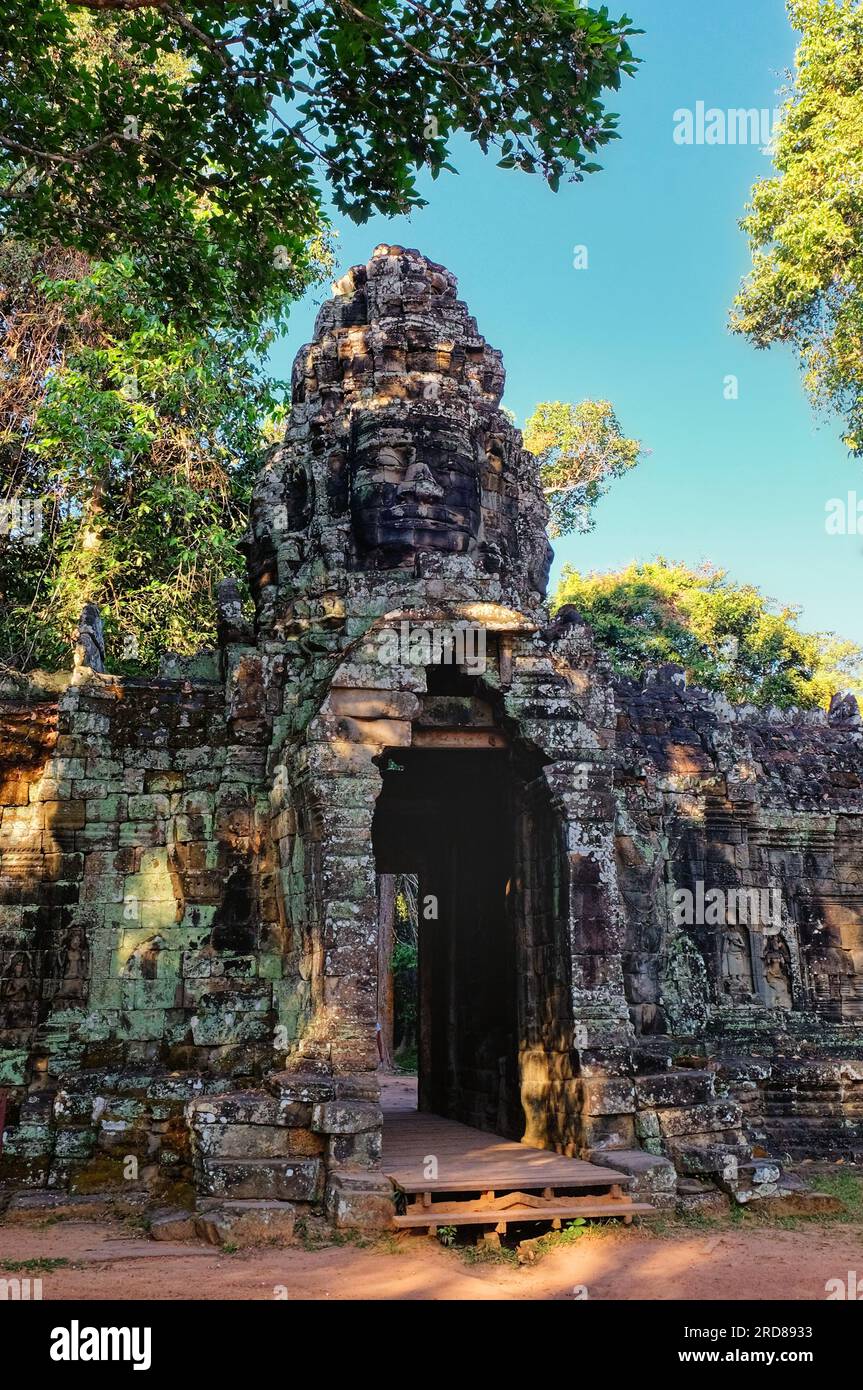 Image displaying a tall stone arch with a tower adorned with human face ...
