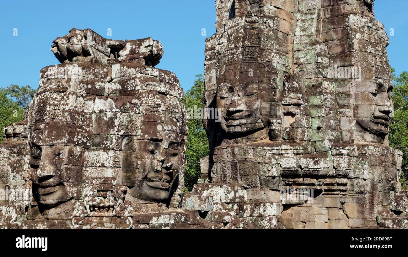 Stone human faces on the towers of the Bayon Temple, an architectural ...