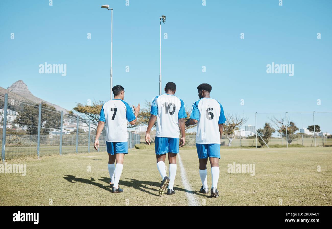 Soccer, team and walking on field with back or conversation at training ...