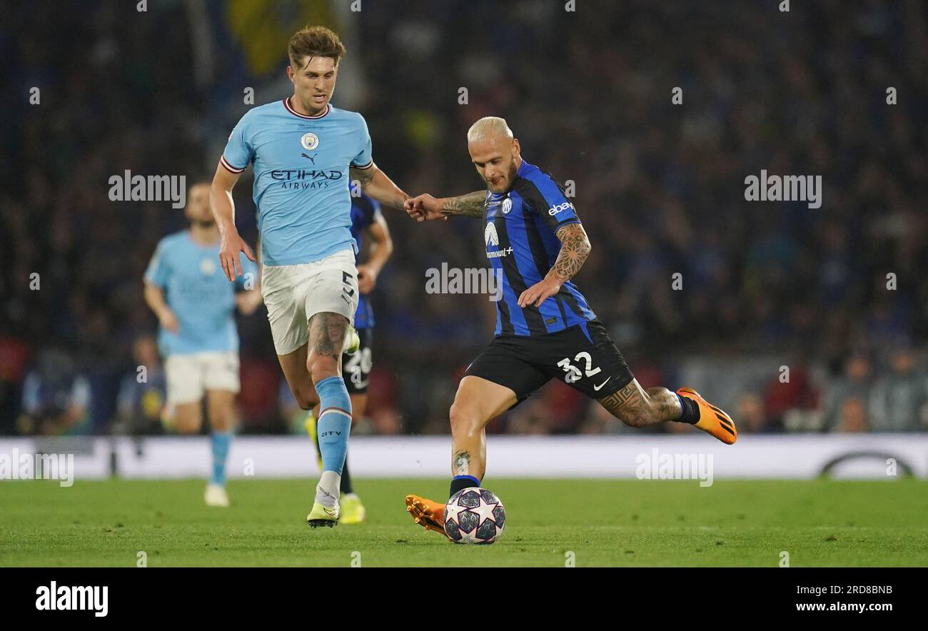 Inter Milan's Federico Dimarco holds off Manchester City's John Stones ...