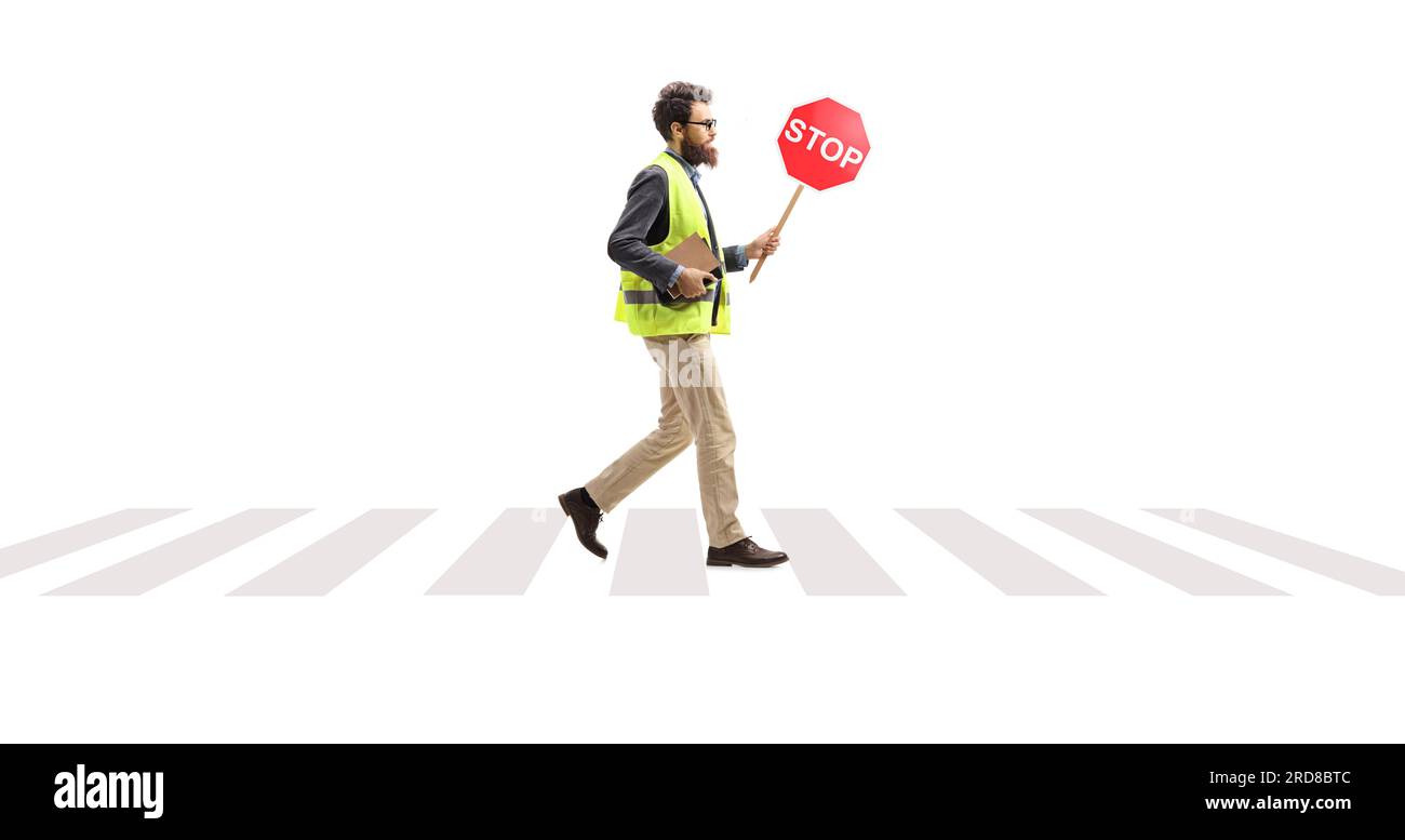 Full length shot of a man carrying books and a stop sign across a ...