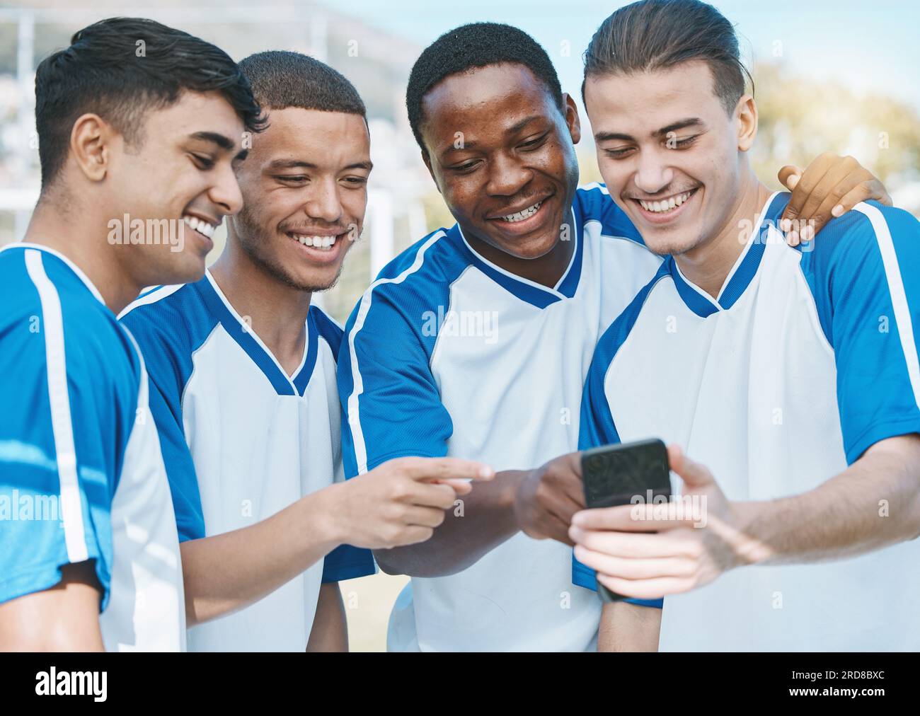 Happy man, friends and soccer team with phone for social media ...