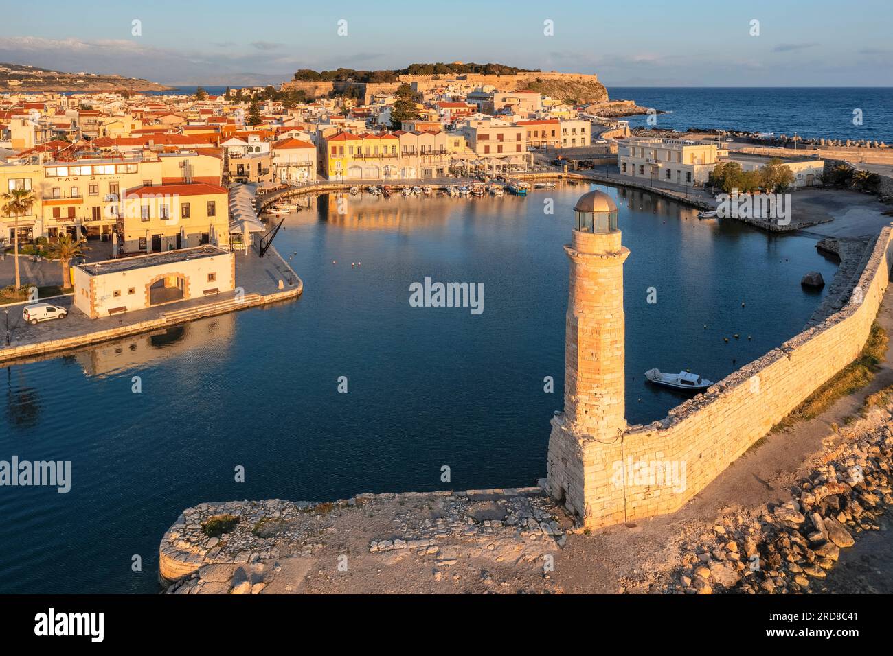 Lighthouse at the Venetian harbor with a view of Venetian Fortezza ...