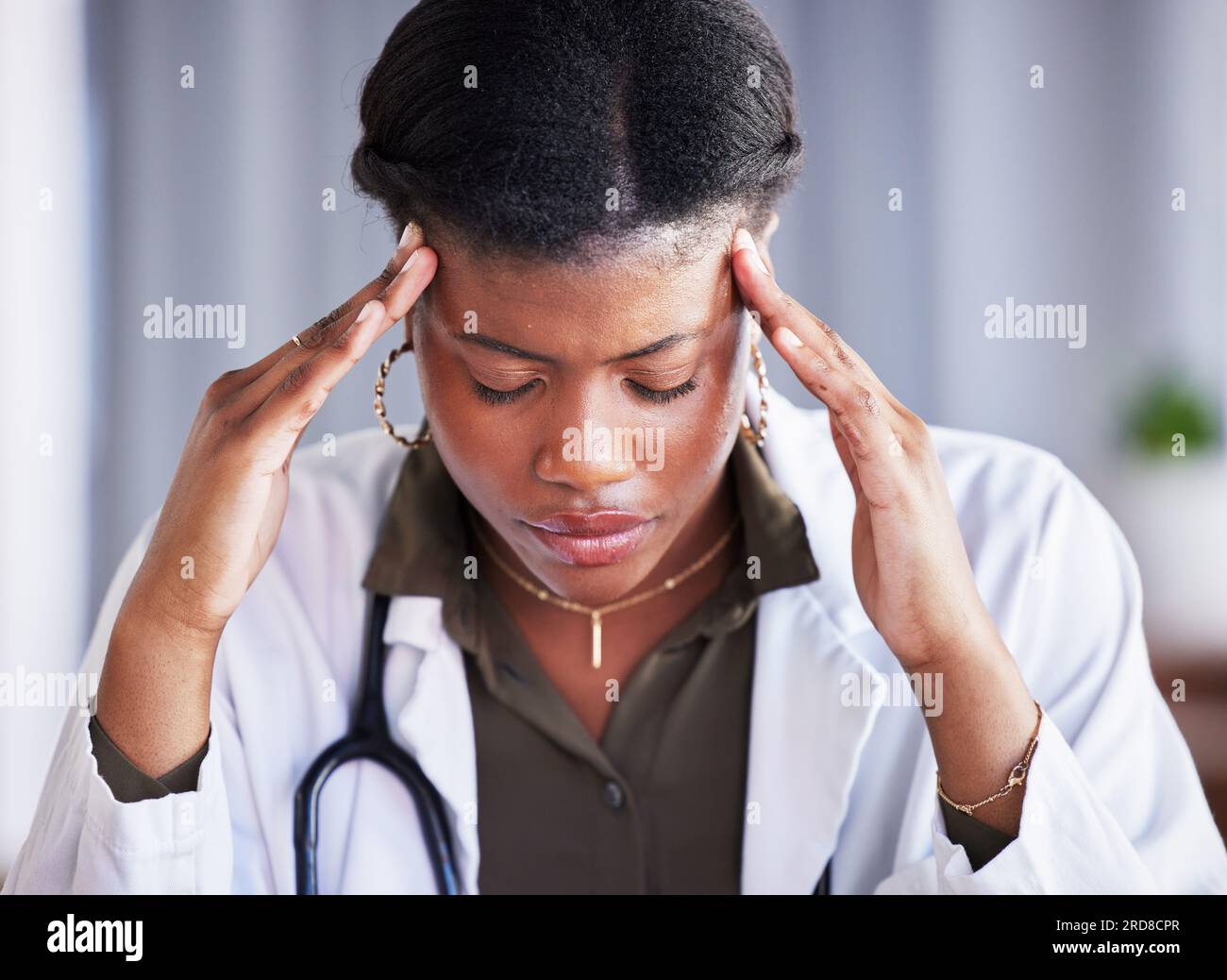 Tired doctor, black woman and stress with headache at clinic, office ...