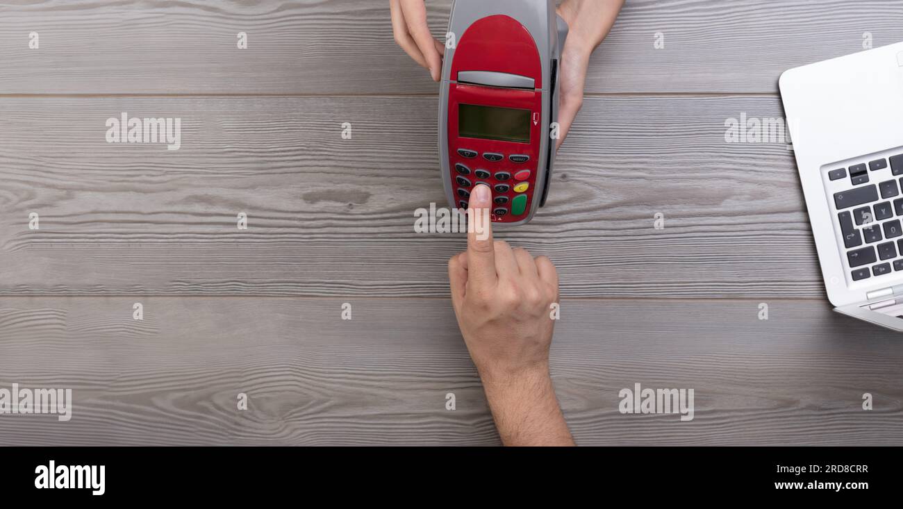 Top view of hands on a rough wooden counter. Merchant and customer ...