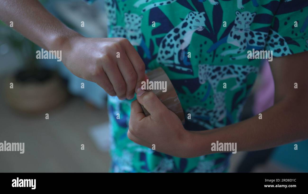 Child hands trying to use duct tape unable to unstrap Stock Photo - Alamy