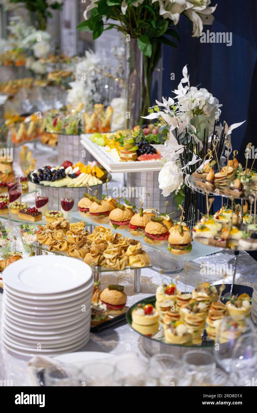 various snacks and drinks at the buffet table at the corporate catering ...