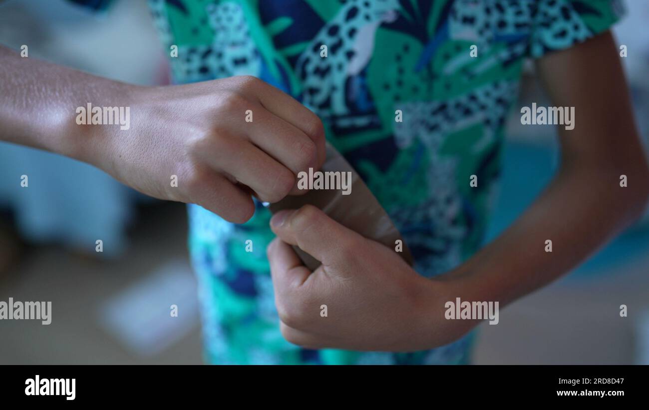 Child hands trying to use duct tape unable to unstrap Stock Photo - Alamy