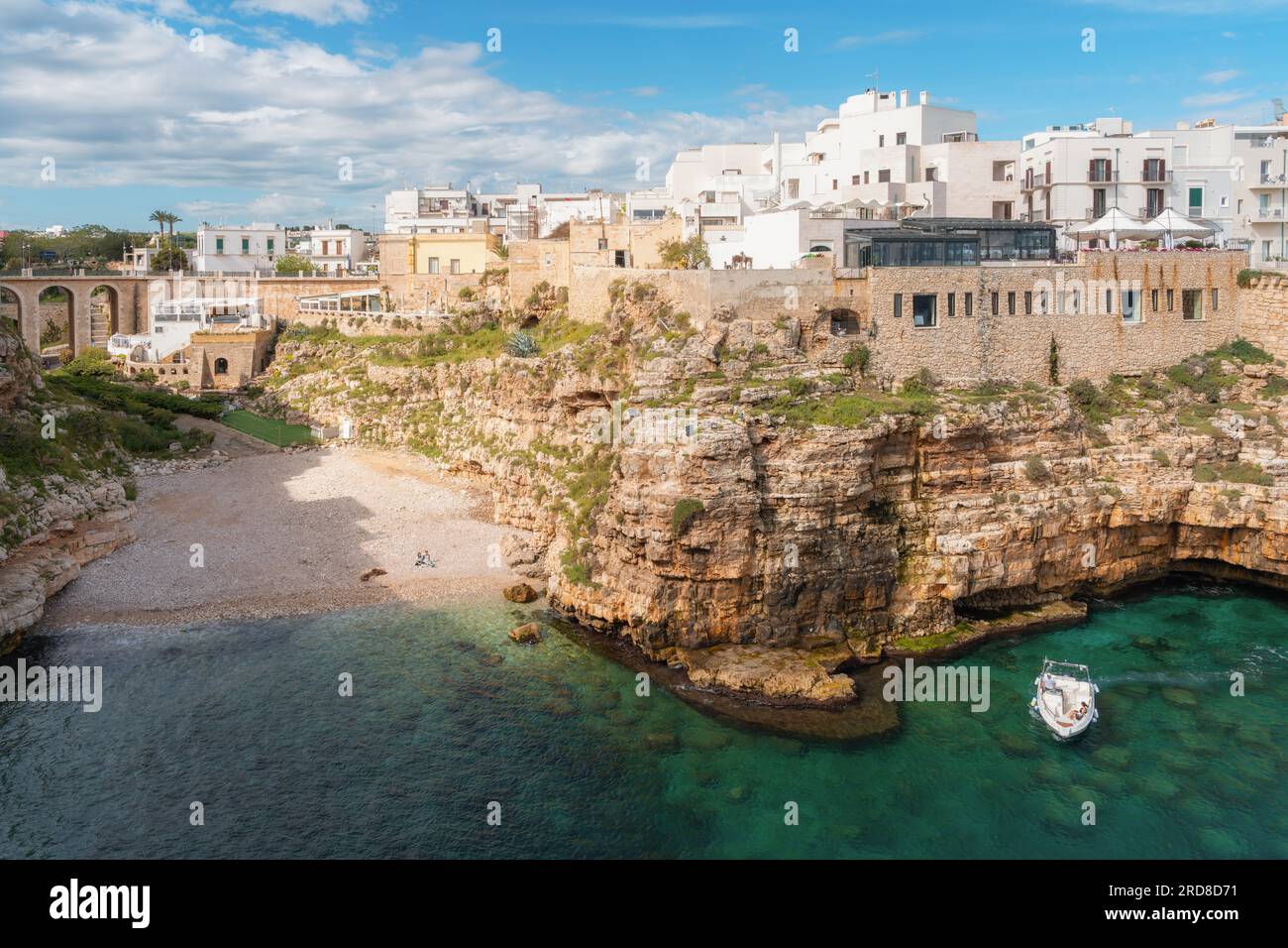 View of beach and old town on limestone cliffs, Polignano a Mare ...