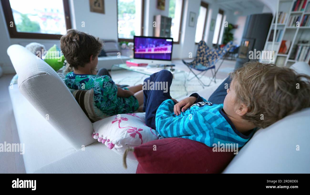 Back of children sitting on sofa watching movie entertainment Stock ...