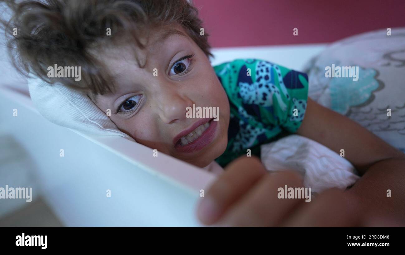 Child grimacing face expression feeling scared and shock Stock Photo ...