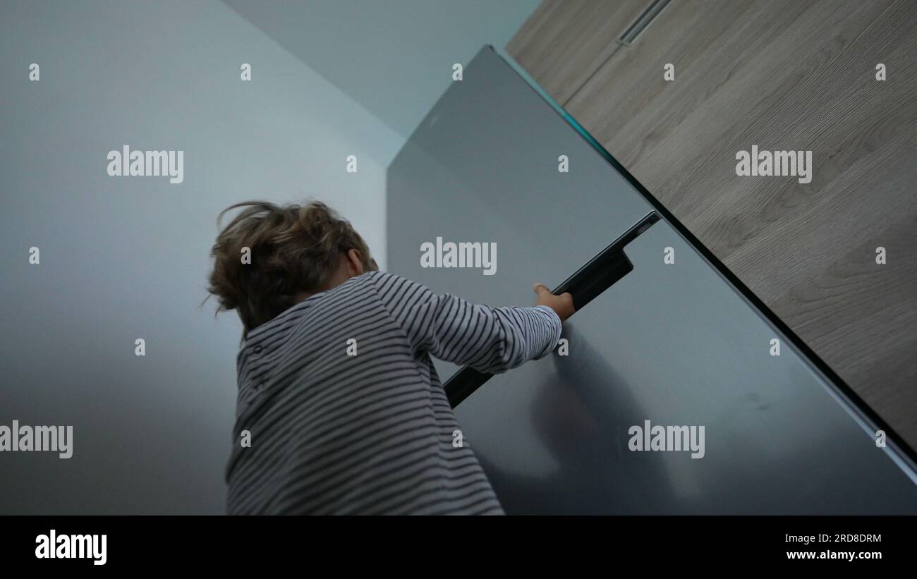 Child opens fridge door kid opening fridge Stock Photo - Alamy